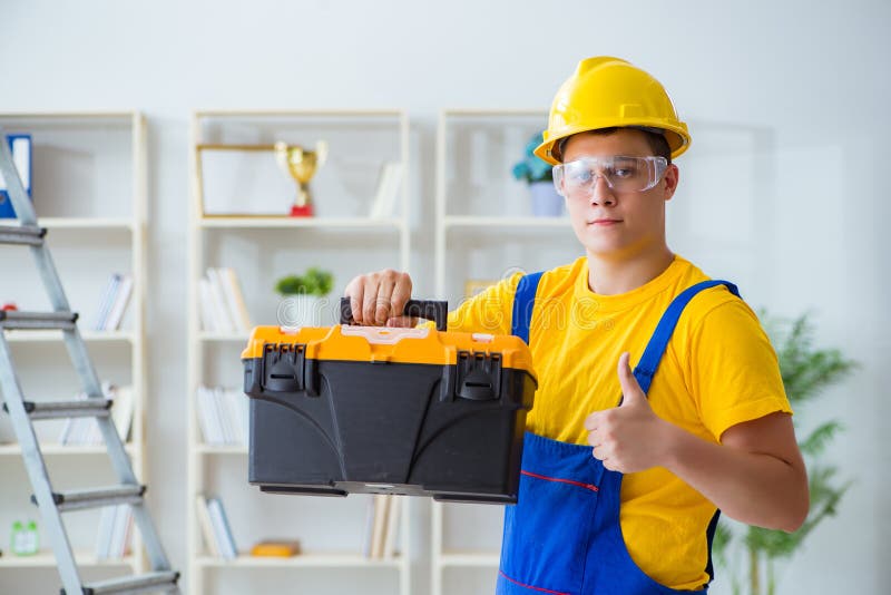 The Young Contractor Doing Repair Works at Office Stock Photo - Image ...