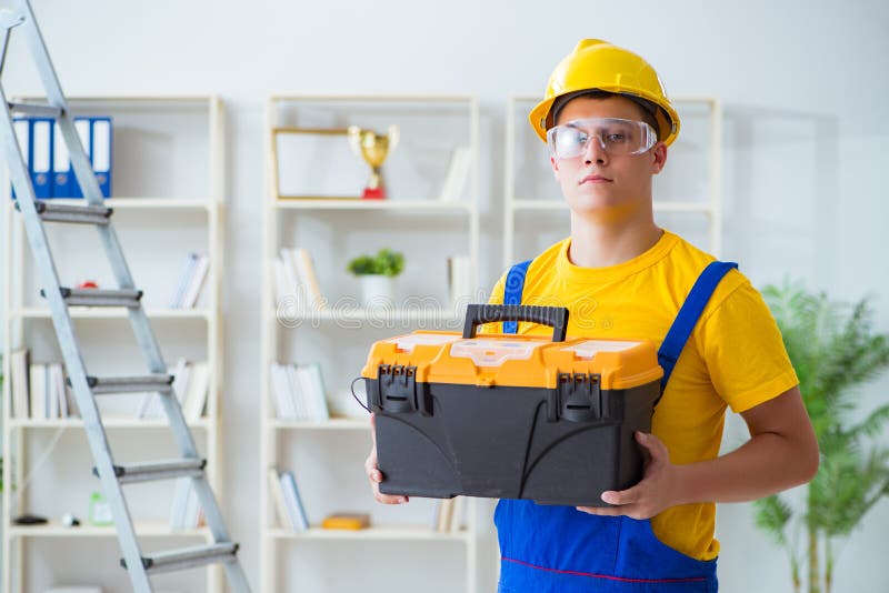 The Young Contractor Doing Repair Works at Office Stock Photo - Image ...