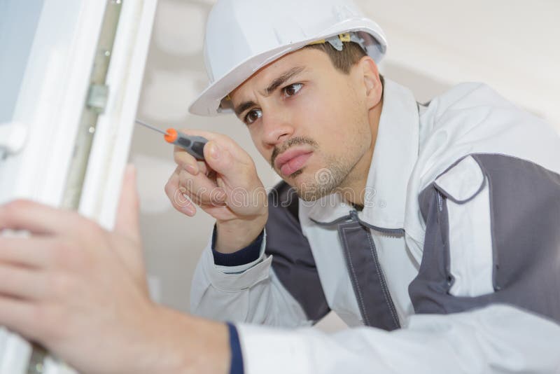 Contractor Using Screwdriver Stock Photo - Image of safety, helmet ...