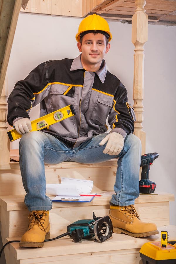 Young Contractor Sitting on Wooden Ladder Holding Constructionh Stock ...