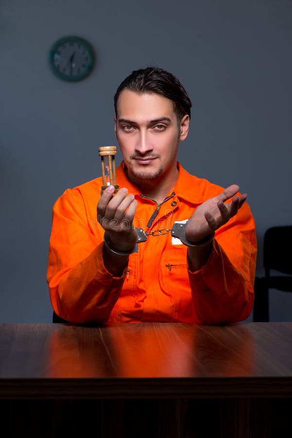 Young Convict Man Sitting in Dark Room Stock Photo - Image of clock ...