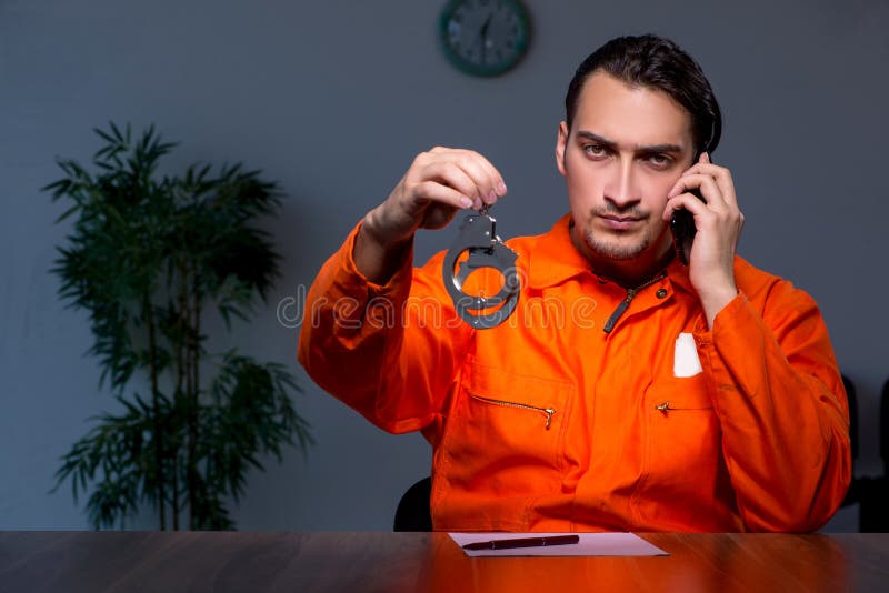 Young Convict Man Sitting in Dark Room Stock Photo - Image of calling ...