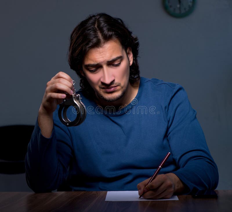 Young Convict Man Sitting in Dark Room Stock Photo - Image of detaining ...