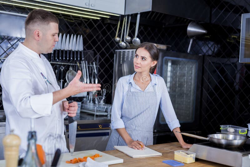 Young Cook Making Notes in the Notebook Stock Photo - Image of cream ...