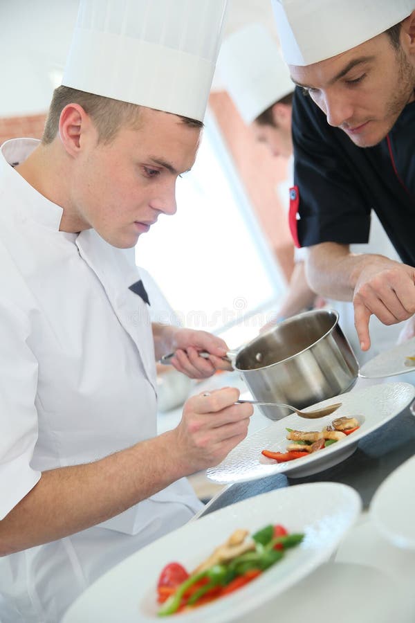 Young Cooking Chef Preparing Dish Stock Image - Image of people, group ...
