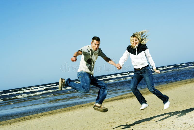 Couple Chasing One Another through Dunes Stock Photo - Image of ...
