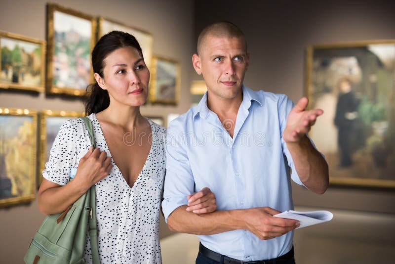 Couple admiring art work stock photo. Image of filipino - 250588706