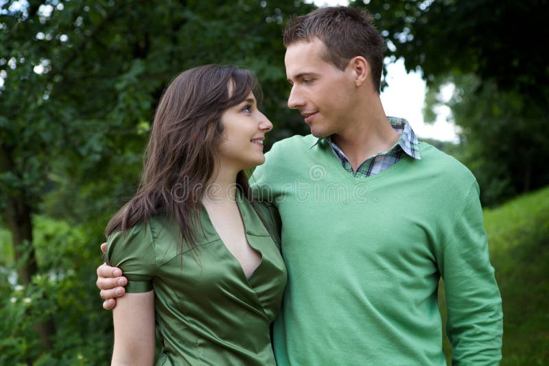 Young Couple with Arm Around and Looking at Each Other Stock Image ...