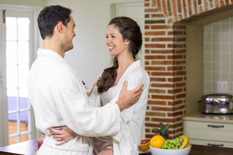 Young Couple in Bathrobe Cuddling Each Other Stock Image - Image of ...