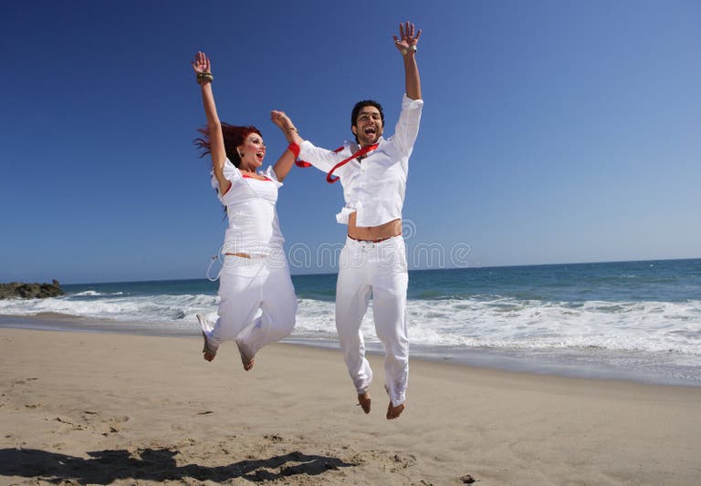 Young Couple at the Beach Jumping for Joy Stock Photo - Image of ...