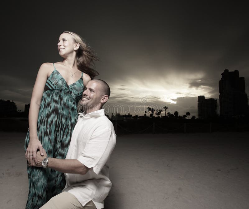 Young Couple at the Beach at Night Stock Image - Image of dusk, dark ...
