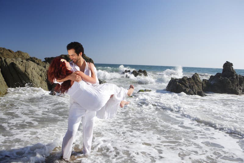 Young Couple at the Beach Playing in Waves Stock Image - Image of young ...