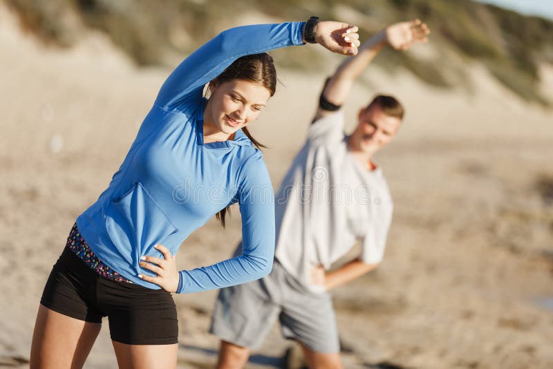 Young Couple on Beach Training Together Stock Image - Image of adult ...