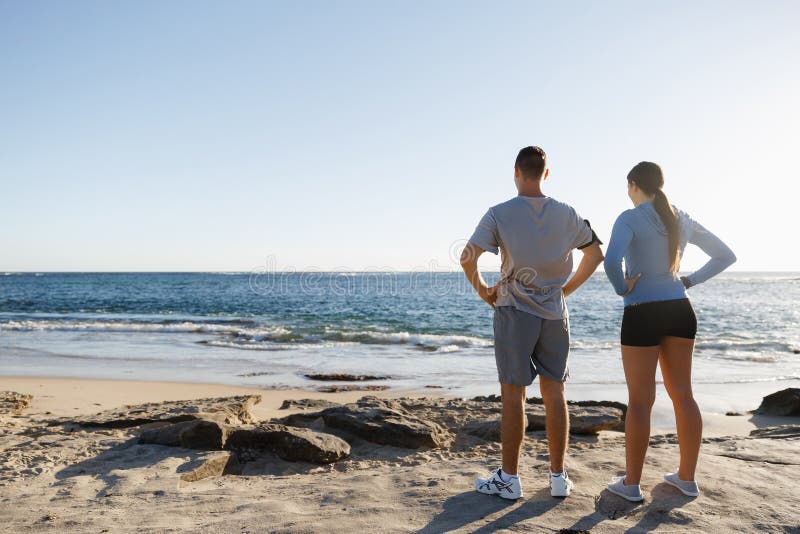 Young Couple on Beach Training Together Stock Photo - Image of runner ...