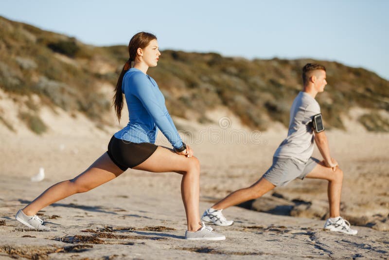Young Couple on Beach Training Together Stock Photo - Image of class ...