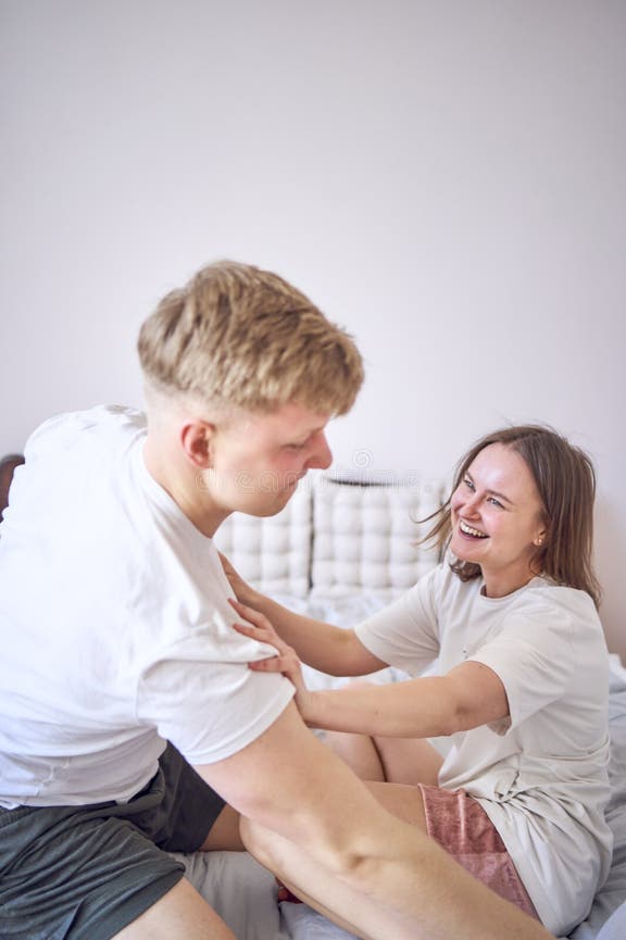 Young Couple on the Bed Playing and Fighting Stock Photo - Image of ...