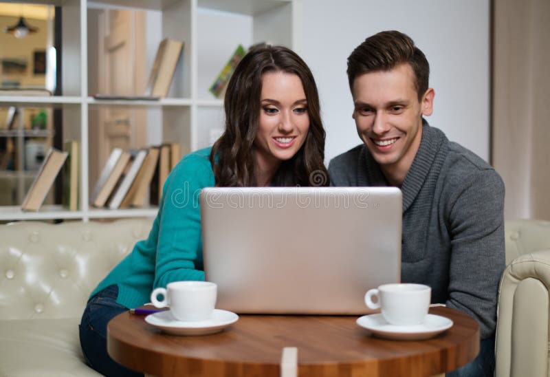 Young Couple Behind Table Discussing Stock Image - Image of people ...