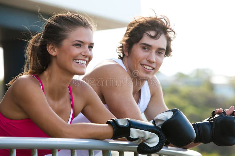Young Couple in Boxing Gloves Leaning on Railing Stock Image - Image of ...