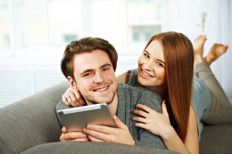 Young Couple Browsing the Internet on a Tablet Stock Image - Image of ...