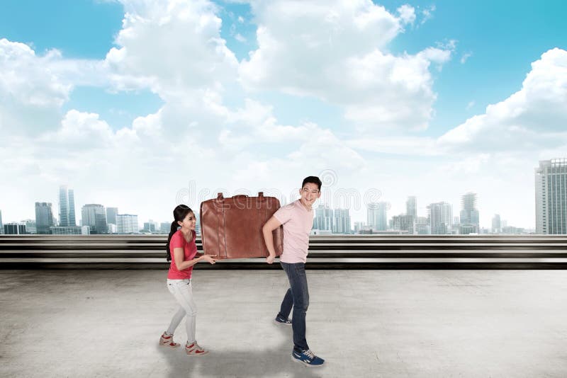 Young couple carry baggage stock image. Image of looking - 56008839