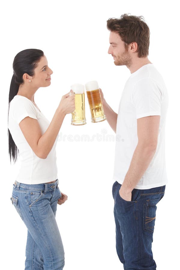 Young Couple Clinking with Mugs of Beer Smiling Stock Photo - Image of ...