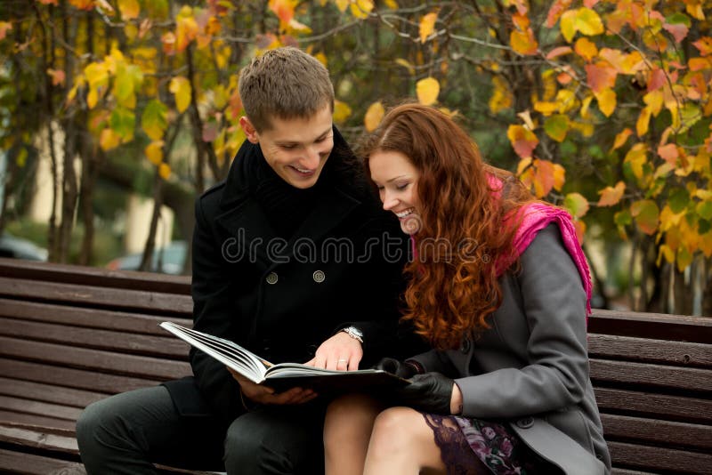 Young Couple is Considering a Book Stock Photo - Image of people ...