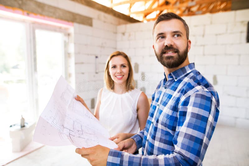 Young Couple at the Construction Site. Stock Image - Image of house ...