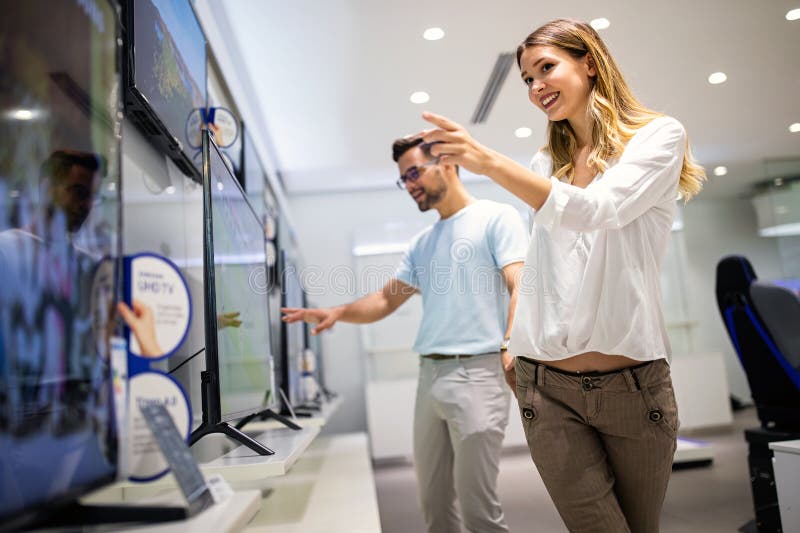 Young Couple in Consumer Electronics Store Looking at Latest Digital ...