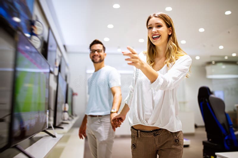 Young Couple in Consumer Electronics Store Looking at Latest Digital ...
