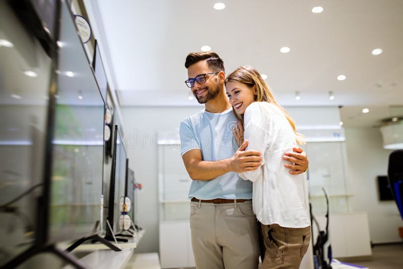 Young Couple in Consumer Electronics Store Looking at Latest Digital ...