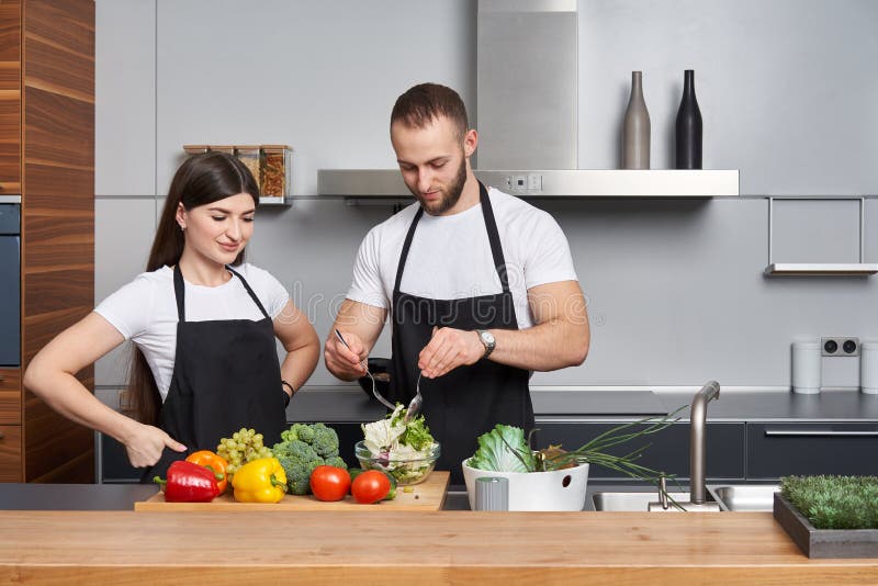 Young Couple Coocking Salad in the Kitchen Stock Image - Image of cook ...