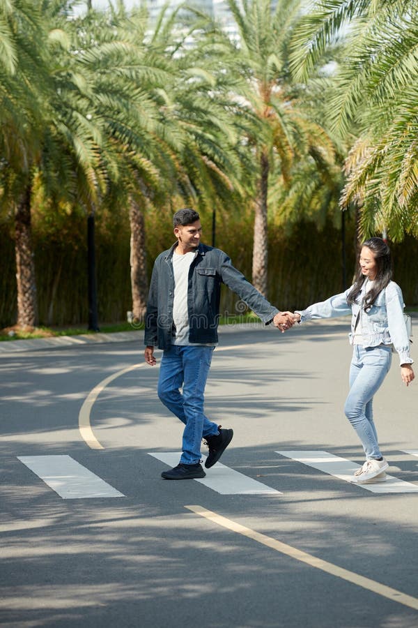 Young Couple Crossing Road stock image. Image of road - 240617045