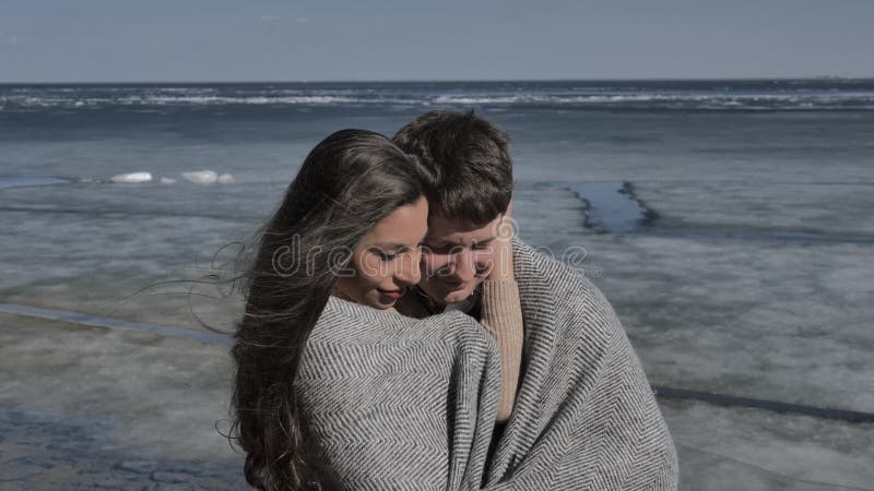 Young Couple Cuddling, in Background a River Covered with Ice, Sunny ...