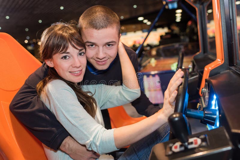 Young Couple Cuddling in Race Car Simulator Stock Photo - Image of play ...