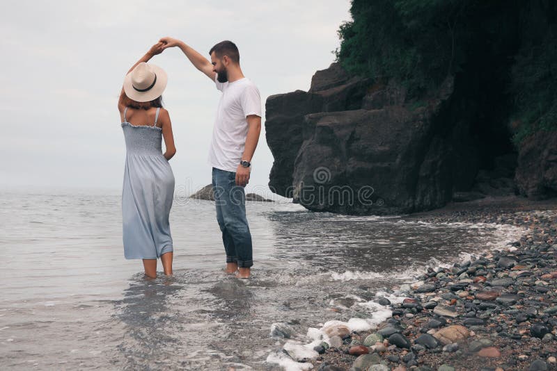 Young Couple Dancing on Beach Near Sea. Space for Text Stock Image ...