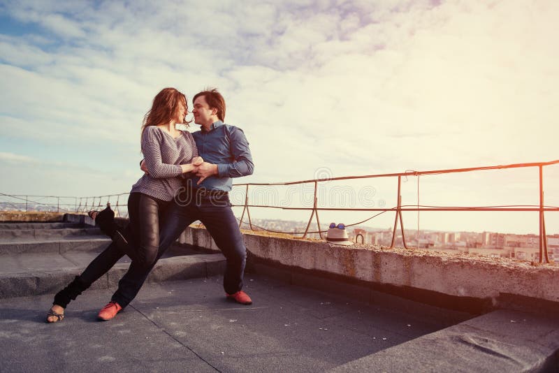 Young Couple Dancing on the Roof of a Tall Building Stock Image - Image ...