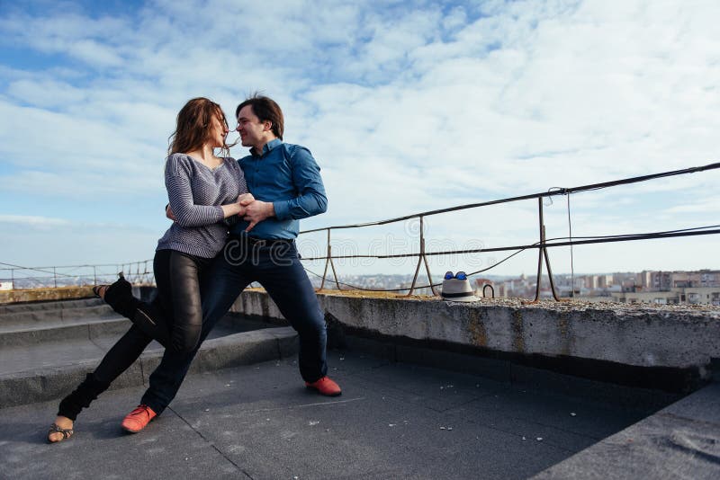 Young Couple Dancing on the Roof of a Tall Building Stock Image - Image ...