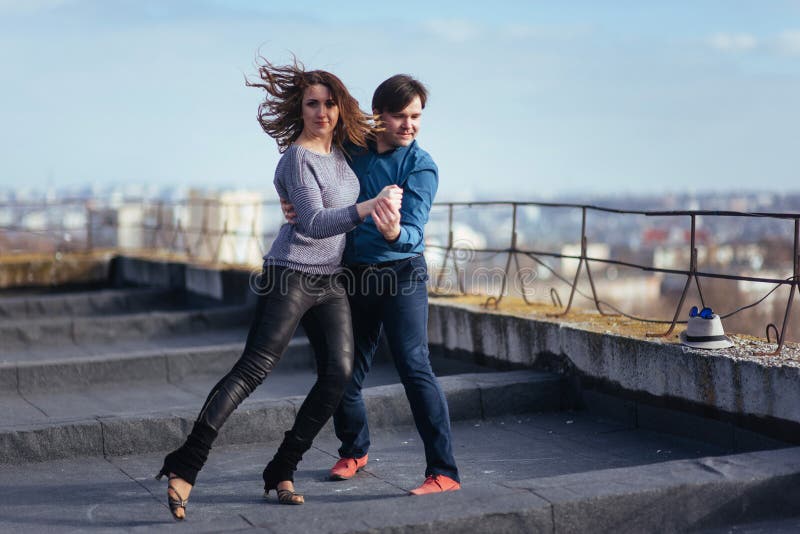 Young Couple Dancing on the Roof of a Tall Building Stock Photo - Image ...
