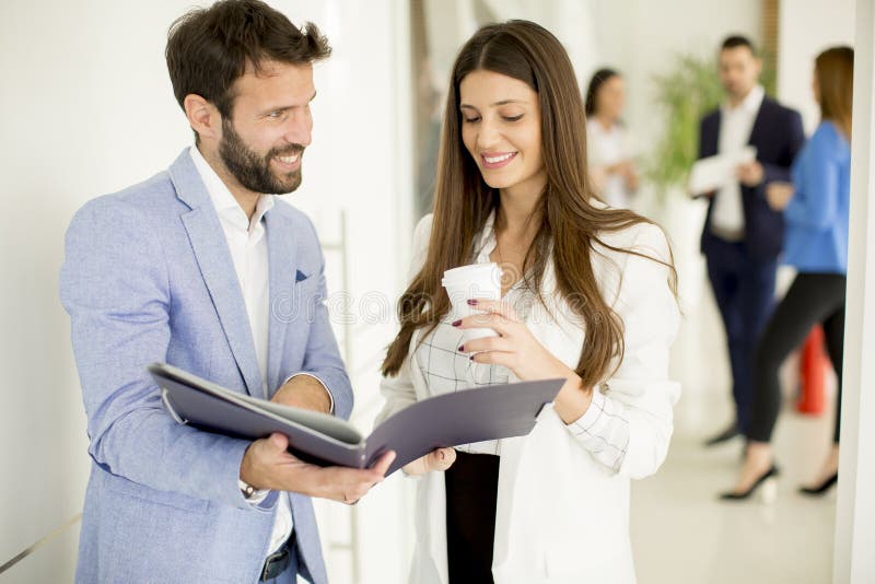Young Couple Discussing about Business in a Modern Office Stock Image ...
