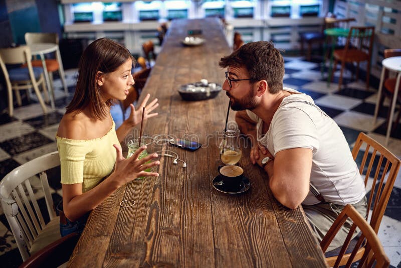 Young Couple Discussing in a Cafe Stock Image - Image of arguing ...