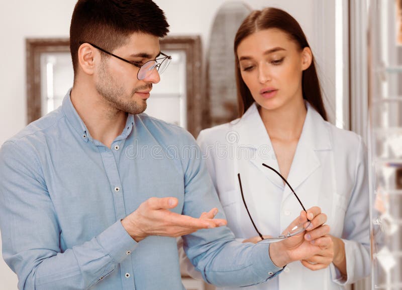 Young Couple Discussing Eyeglasses in an Optical Store during Daylight ...