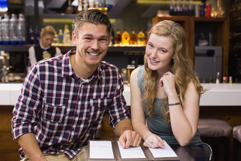 Young Couple Discussing the Menu Stock Image - Image of friendship ...