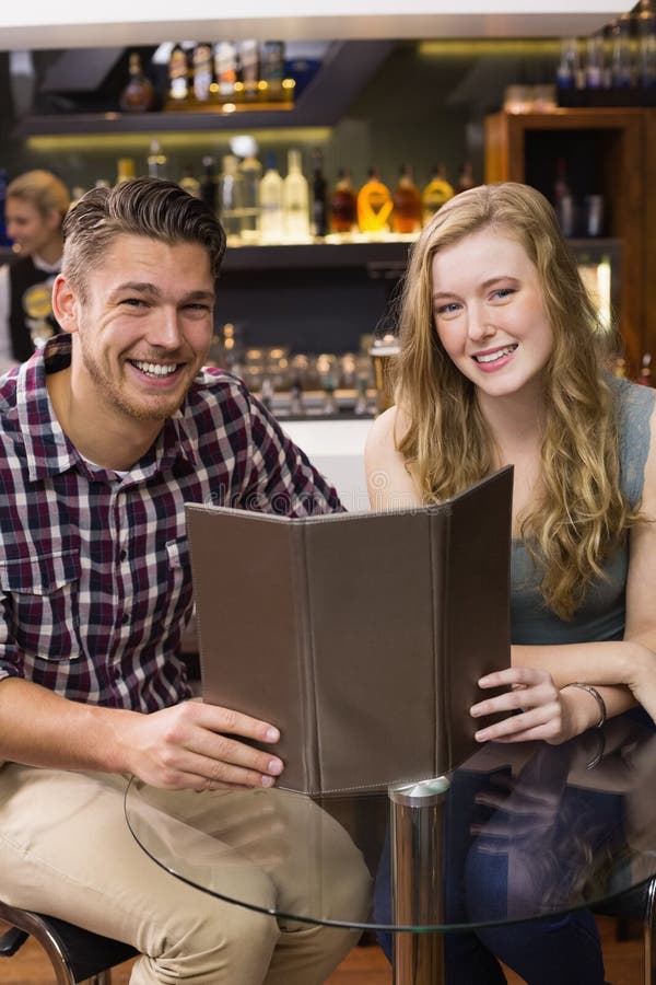 Young Couple Discussing the Menu Stock Image - Image of caucasian ...