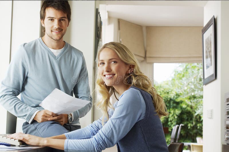 Young Couple with Documents and Computer Stock Image - Image of holding ...