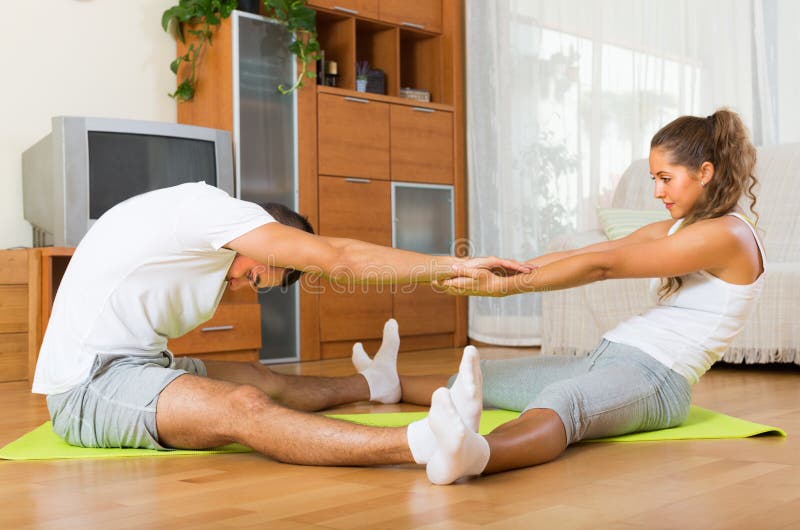 Young Couple Doing Exercises Together Stock Photo - Image of female ...