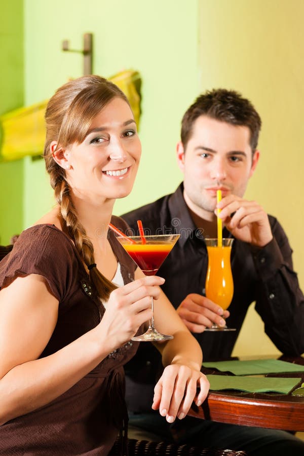 Young Couple Drinking Cocktails in Bar Stock Photo - Image of ...