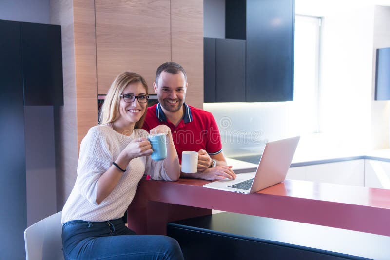 Couple Drinking Coffee and Using Laptop at Home Stock Photo - Image of ...