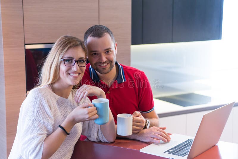 Couple Drinking Coffee and Using Laptop at Home Stock Image - Image of ...