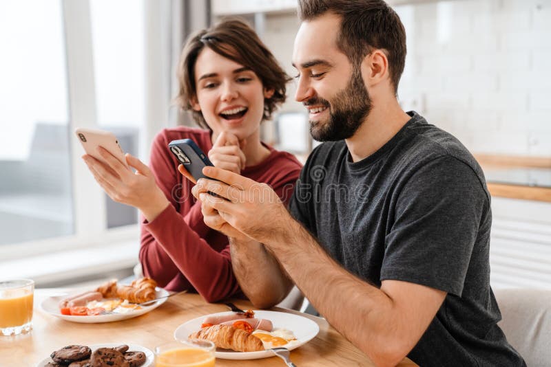 Young Couple Eating Breakfast in the Kitchen Stock Photo - Image of ...