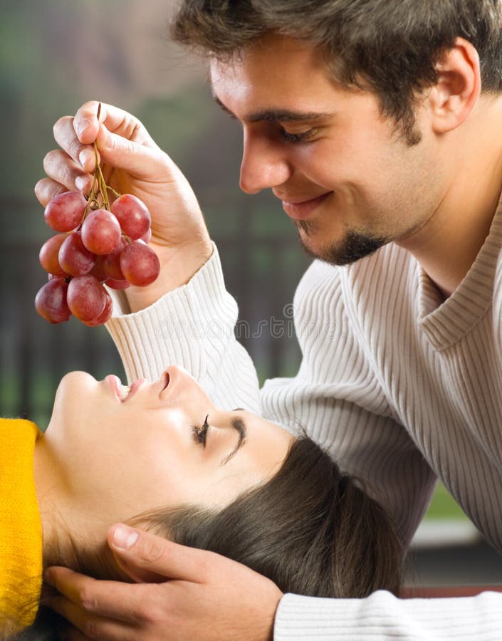 Couple Playfully Eating Grapes Stock Photo - Image of couple, meeting ...